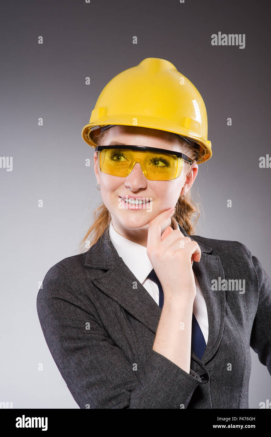 Female engineer with helmet isolated on gray Stock Photo - Alamy