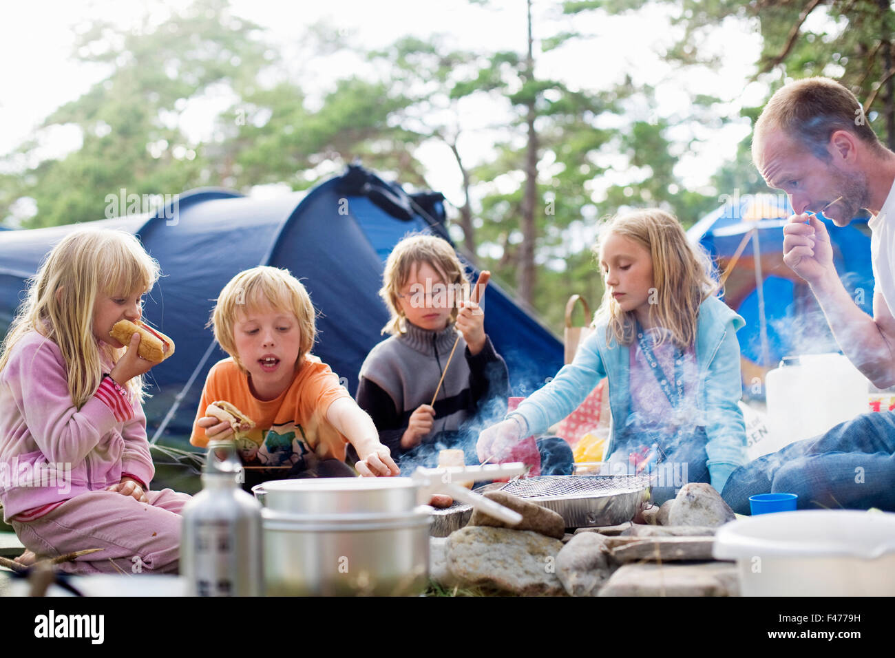 A family eating food outside a tent, Sweden Stock Photo - Alamy