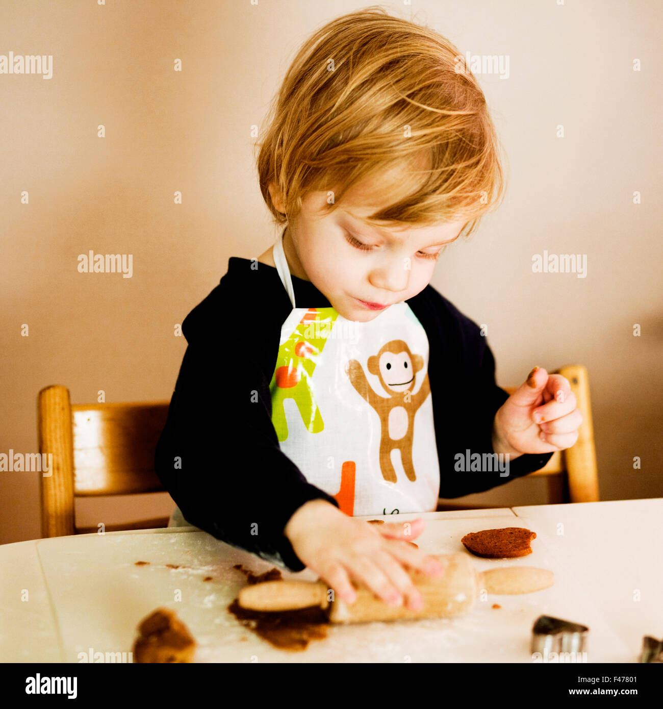 A boy making gingerbread biscuits for Christmas Stock Photo - Alamy