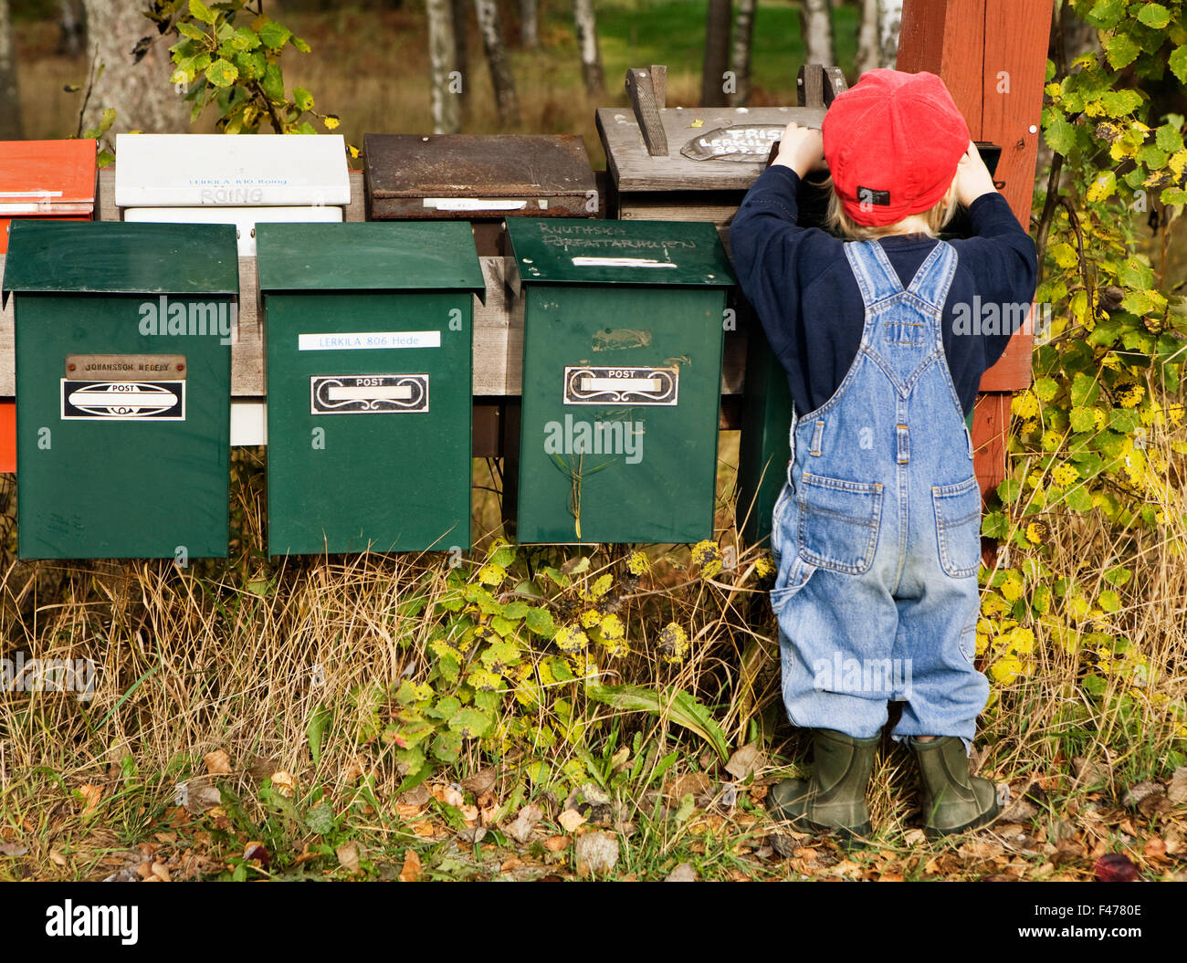 A boy looking in to a mailbox, Sweden Stock Photo - Alamy