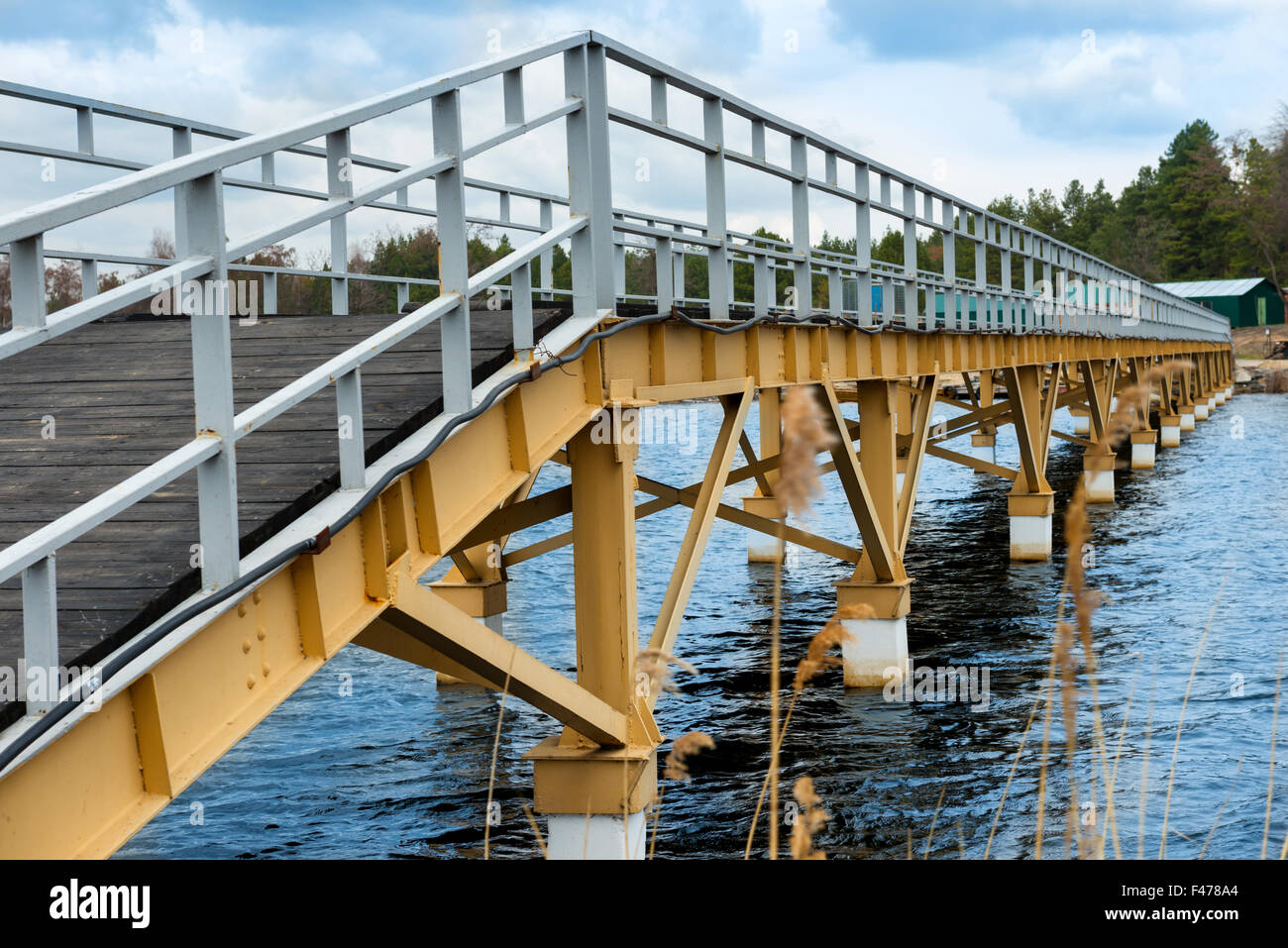 Steel bridge along river bank Stock Photo - Alamy