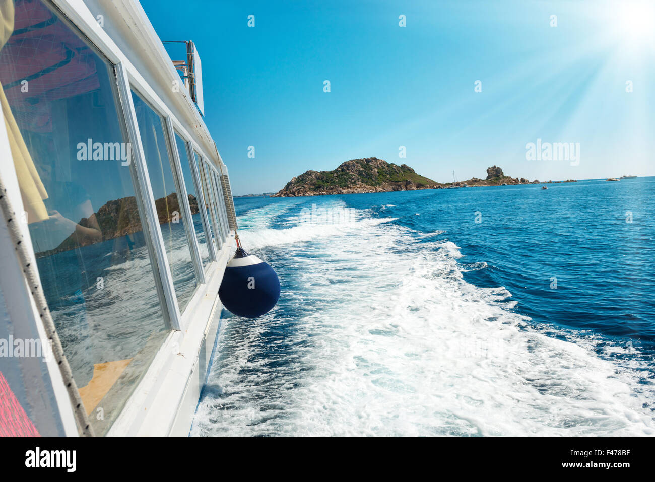 Waves on blue sea behind the boat Stock Photo - Alamy