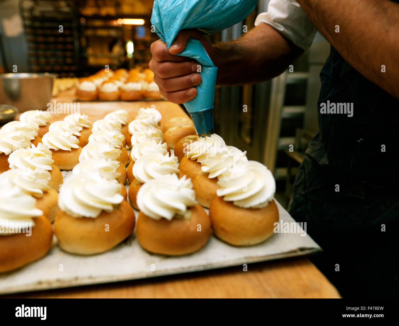 A pastrycook pipes whipped cream, Sweden Stock Photo - Alamy