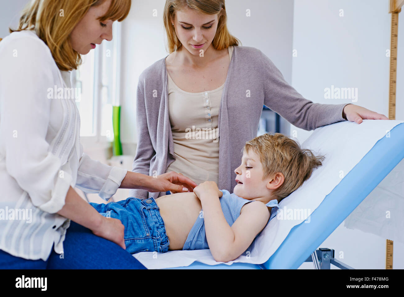 Doctor palpating the stomach hi-res stock photography and images - Alamy