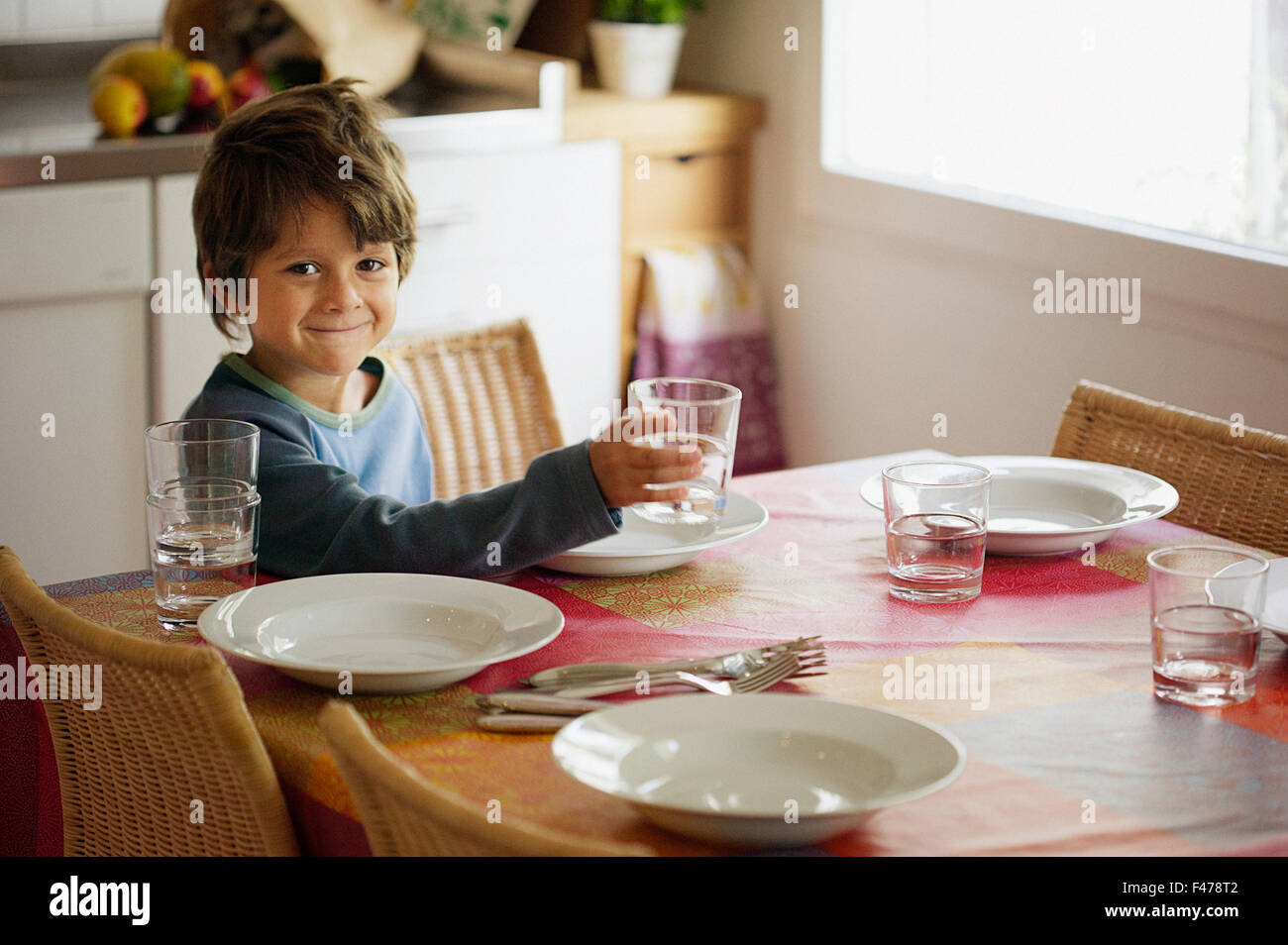 A little boy laying the table, Sweden Stock Photo - Alamy