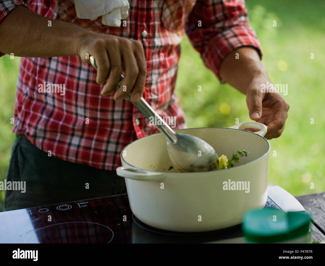 Man cooking outdoors, Sweden Stock Photo - Alamy