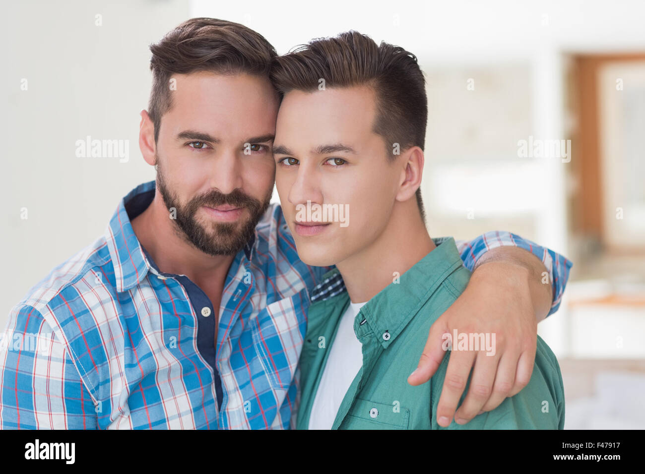 Homosexual couple men looking at the camera Stock Photo - Alamy