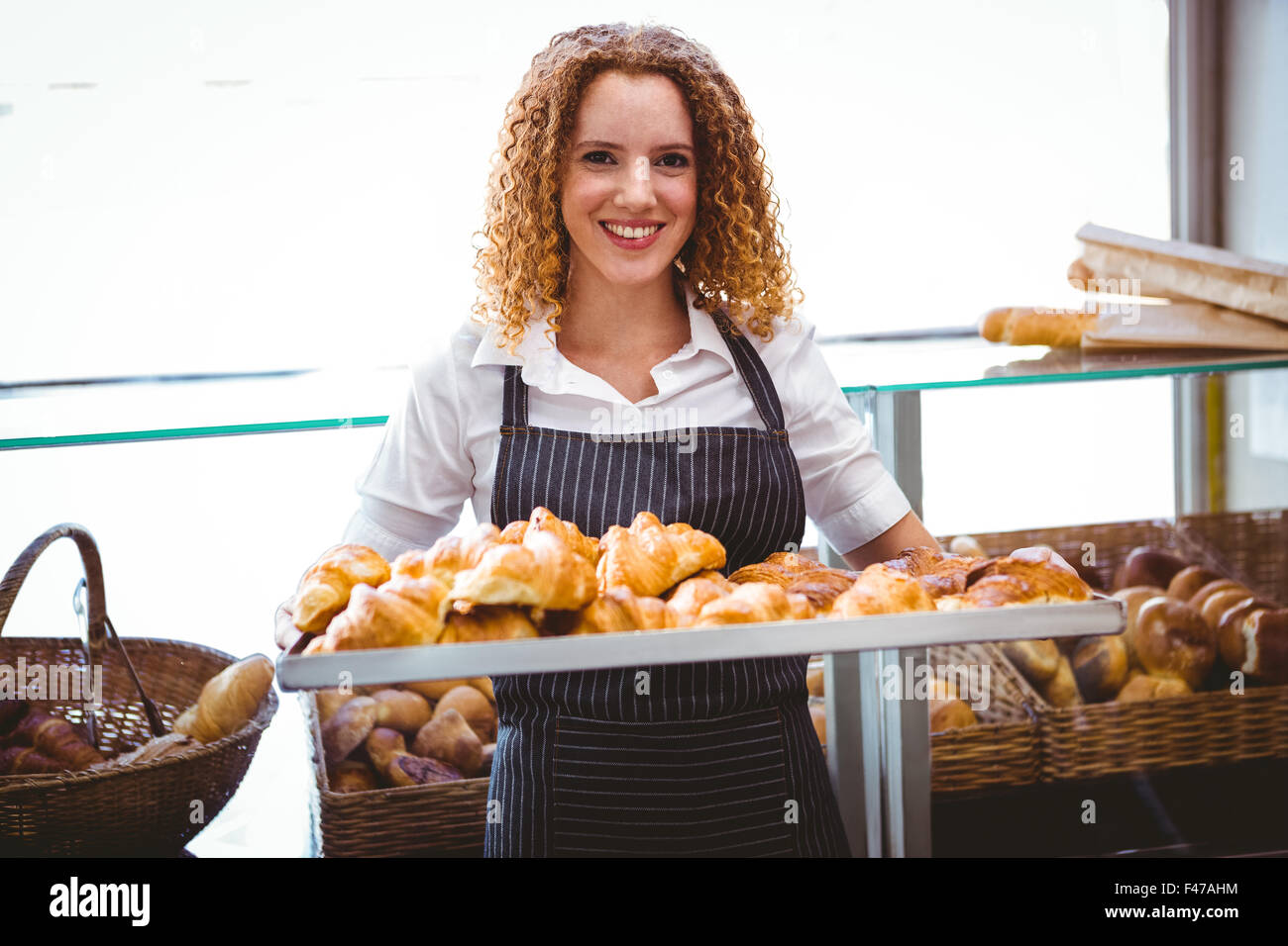 Happy pretty barista holding plate with pastry Stock Photo - Alamy