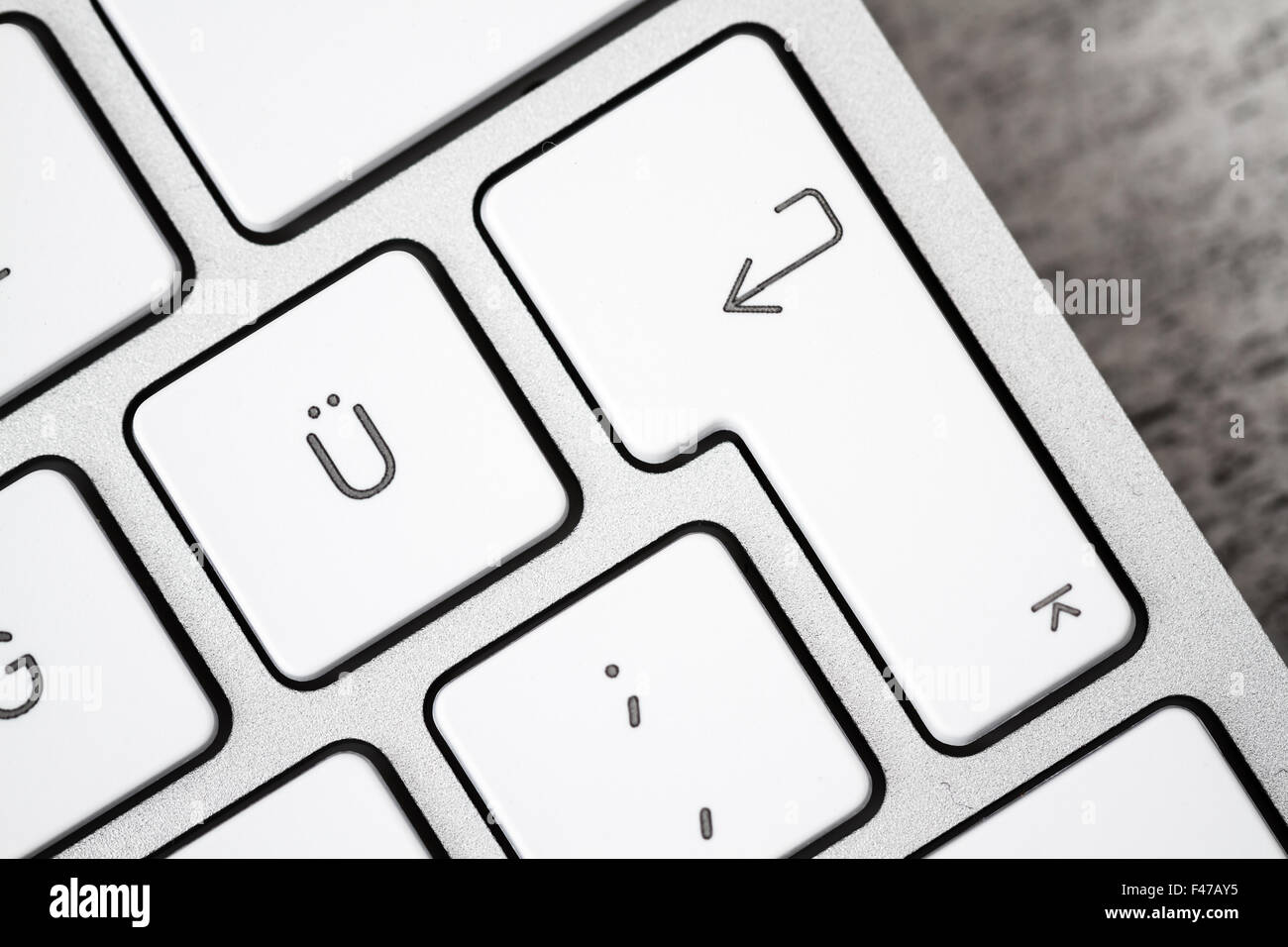 Close up of a white, gray computer keyboard. Focus on enter key Stock ...