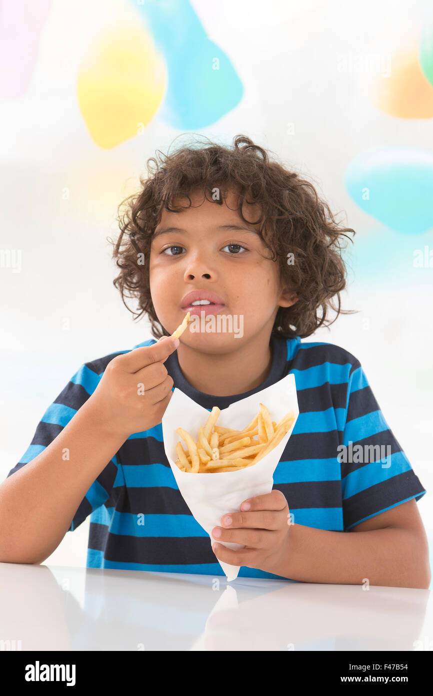 Overweight child eating junk food hi-res stock photography and images ...