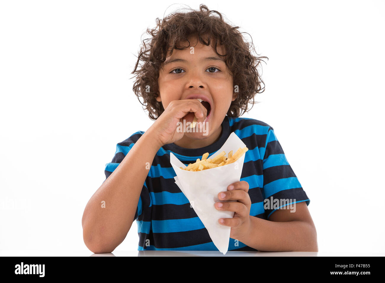 Overweight child eating junk food hi-res stock photography and images ...