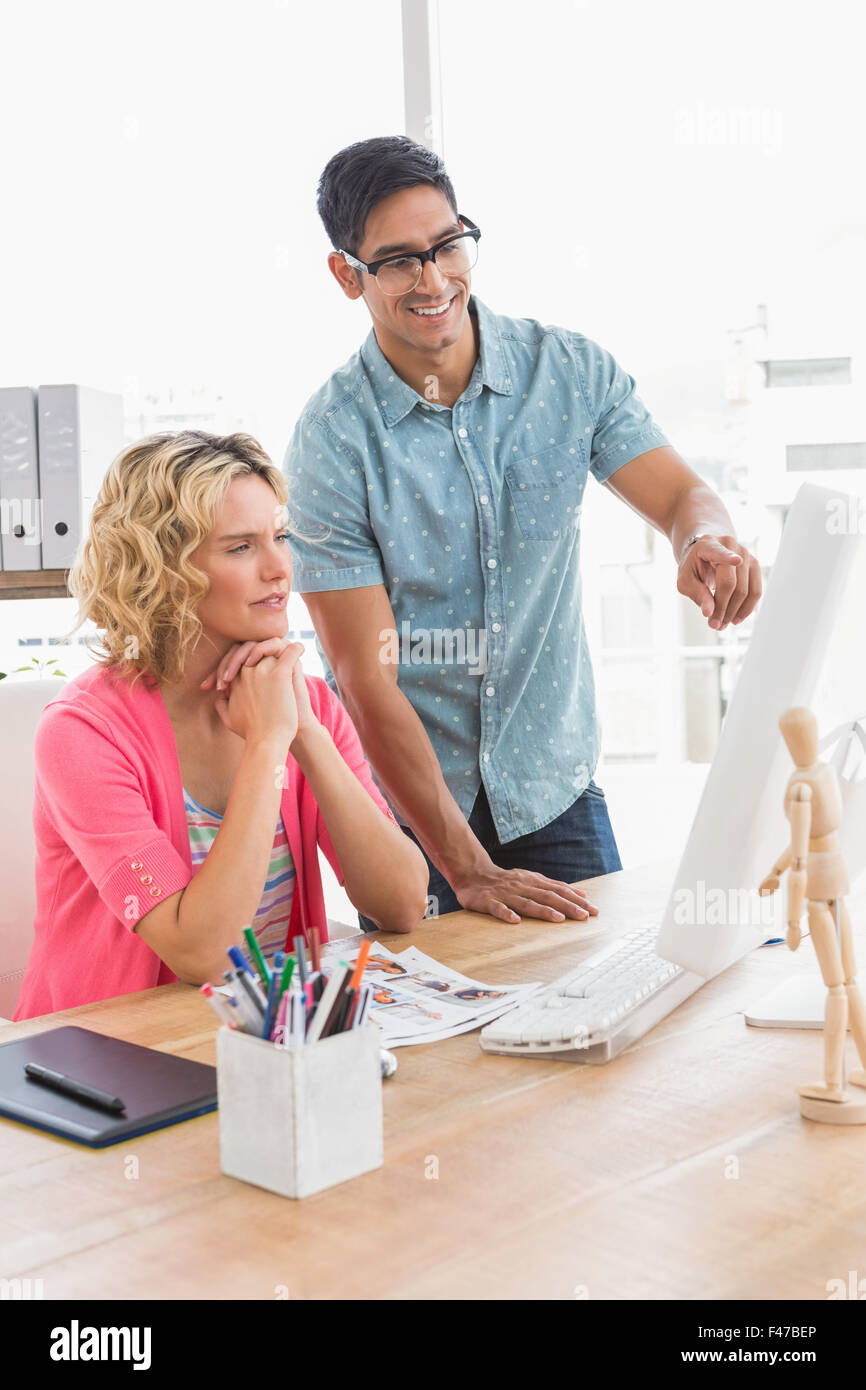 Colleagues using computer and pointing the screen Stock Photo - Alamy