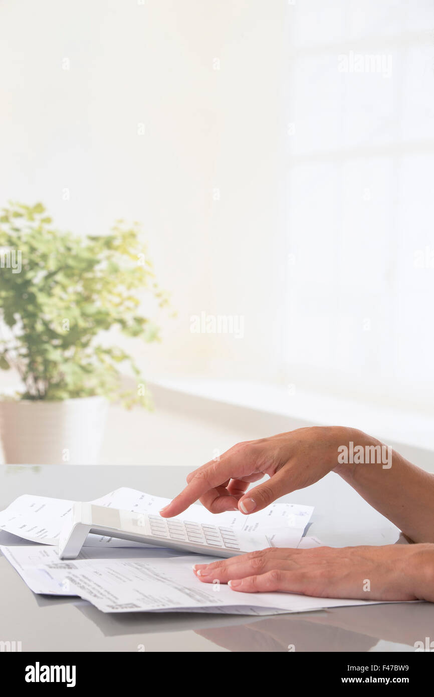woman hand with calculator and papers Stock Photo - Alamy