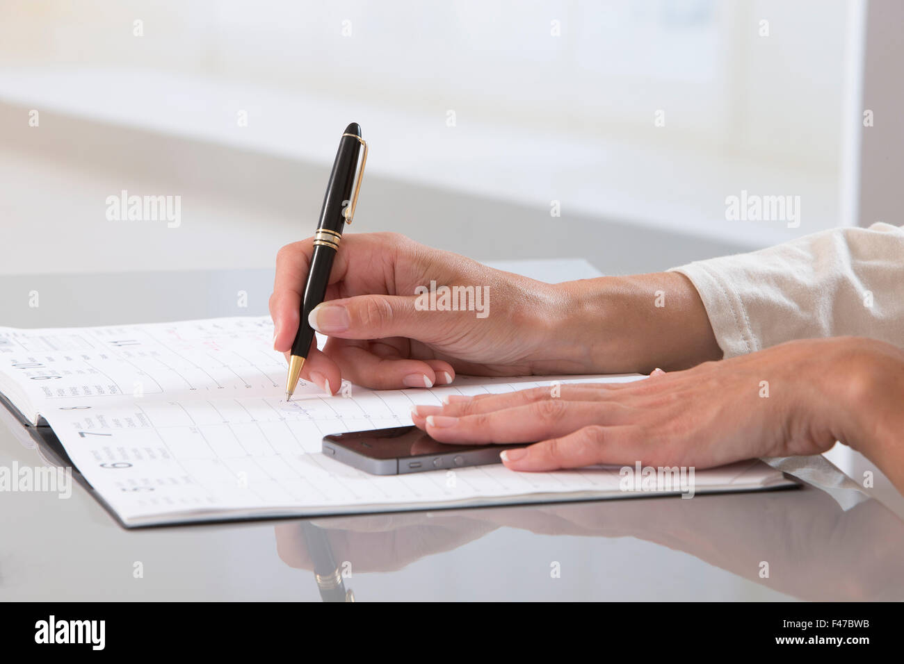 Mature woman writing on diary hi-res stock photography and images - Alamy