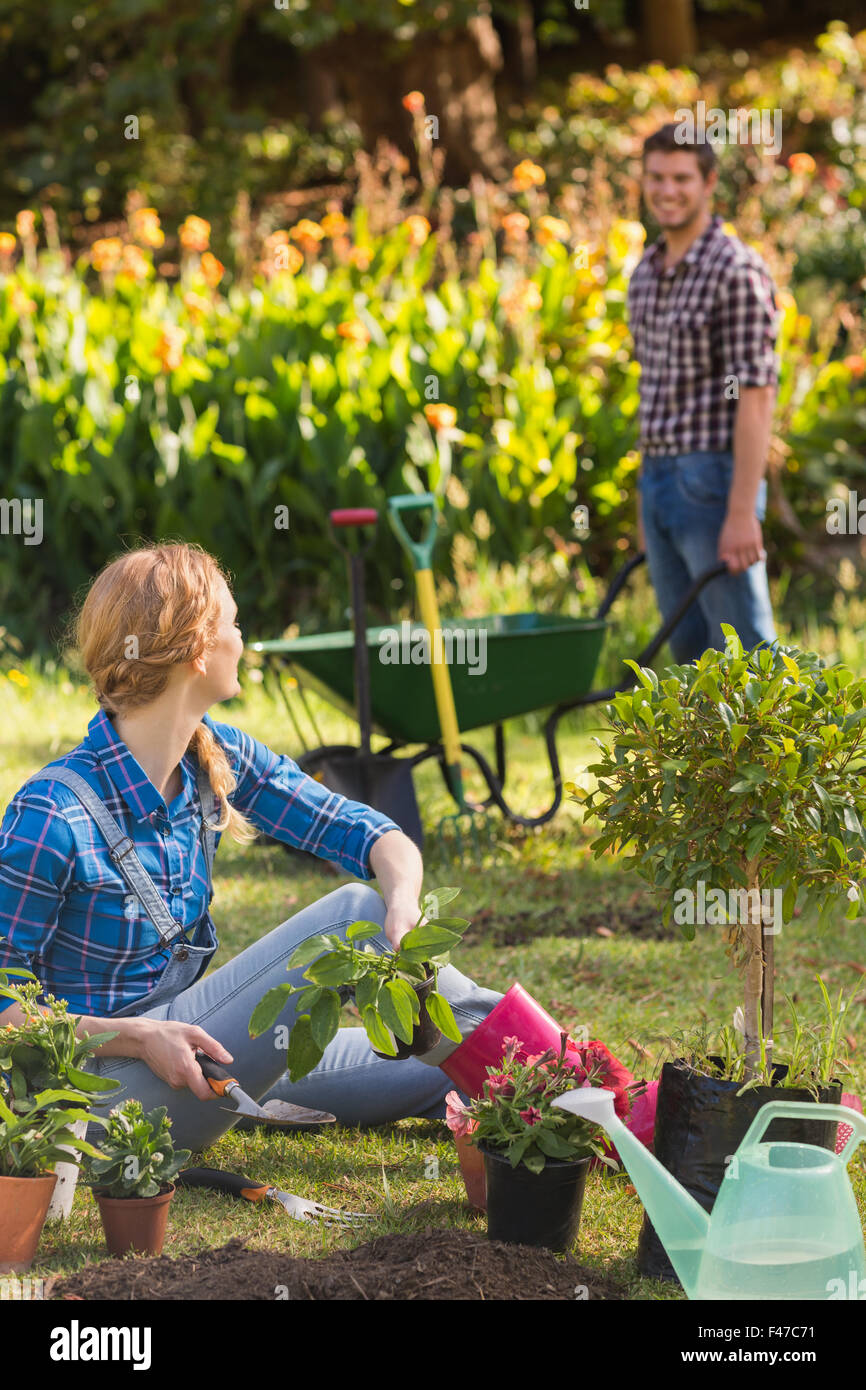 Happy young couple gardening together Stock Photo - Alamy