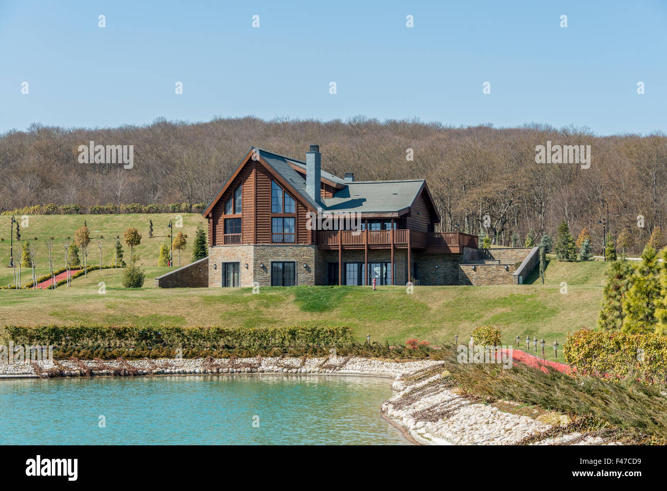 Modern house near water on bright day Stock Photo - Alamy