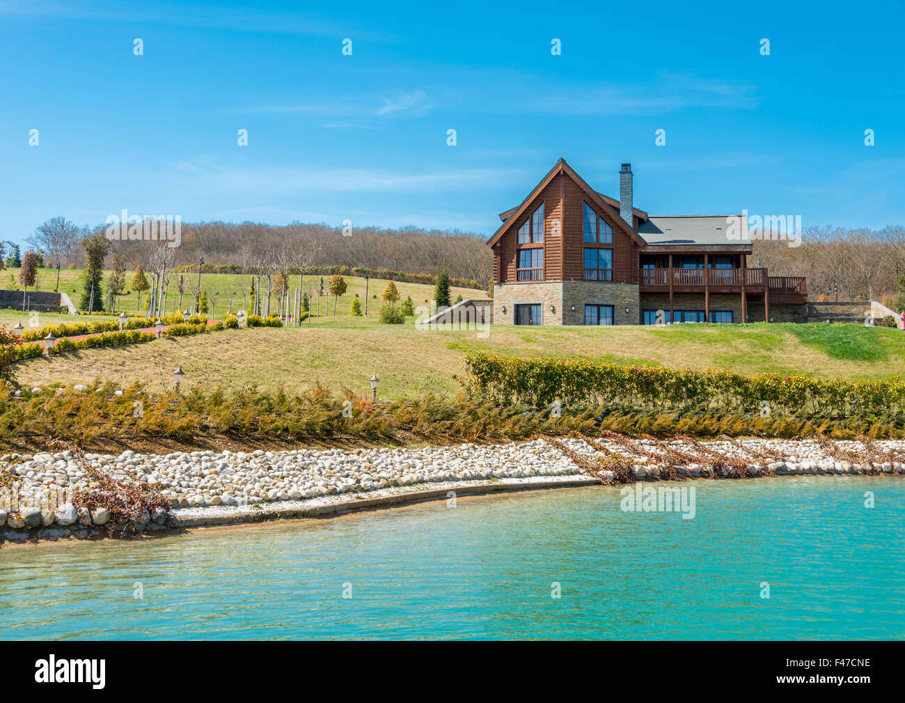 Modern house near water on bright day Stock Photo - Alamy
