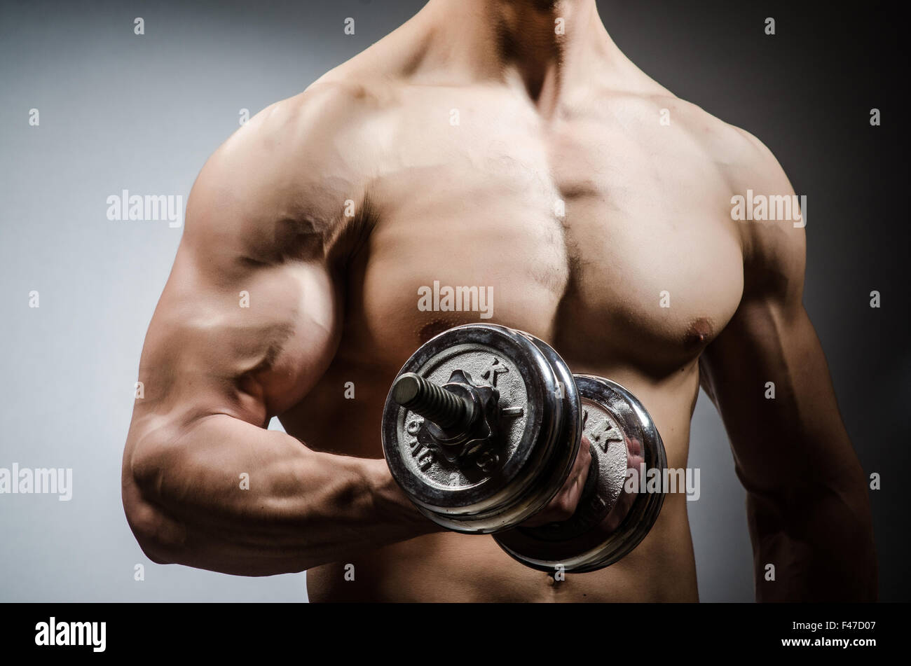 Muscular ripped bodybuilder with dumbbells Stock Photo - Alamy