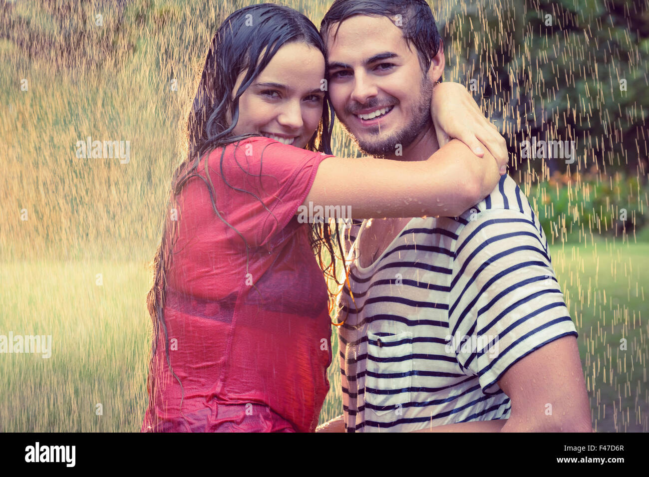 Cute couple hugging under the rain Stock Photo - Alamy