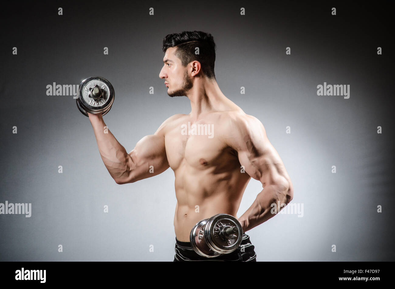 Muscular ripped bodybuilder with dumbbells Stock Photo - Alamy
