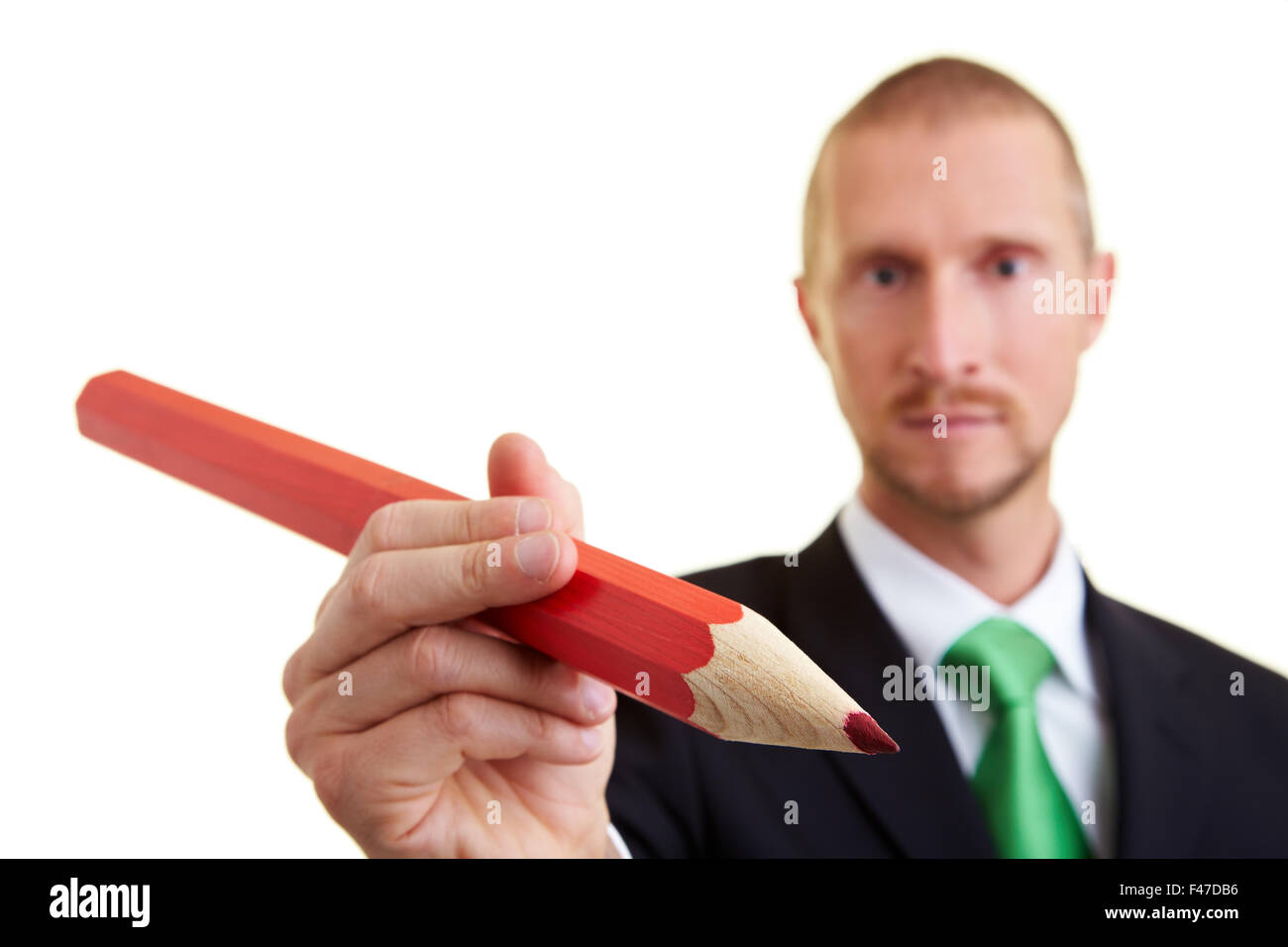 Manager writing with an oversized red pencil Stock Photo - Alamy