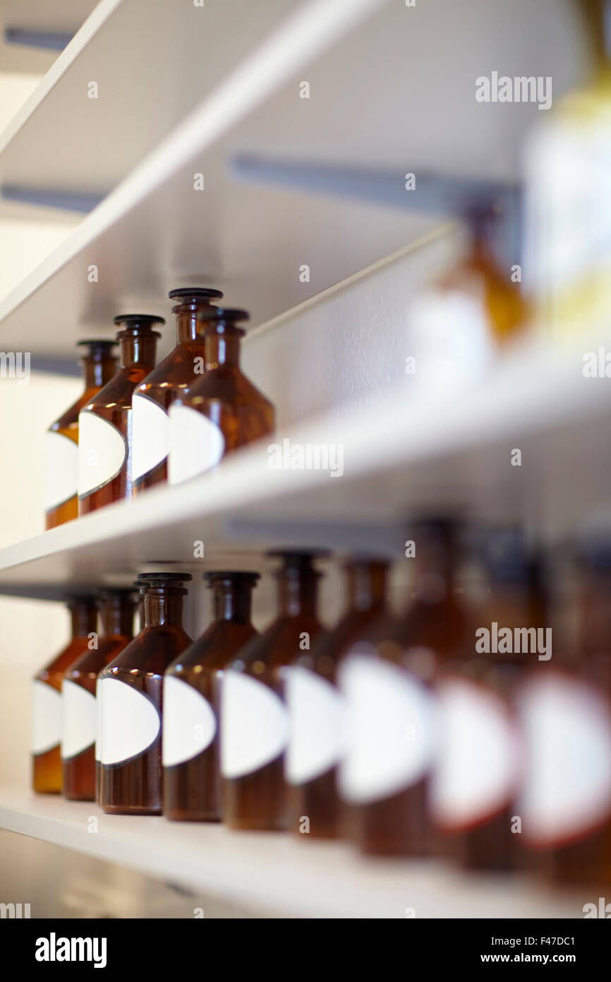 Row of drug bottles in pharmacy lab Stock Photo - Alamy