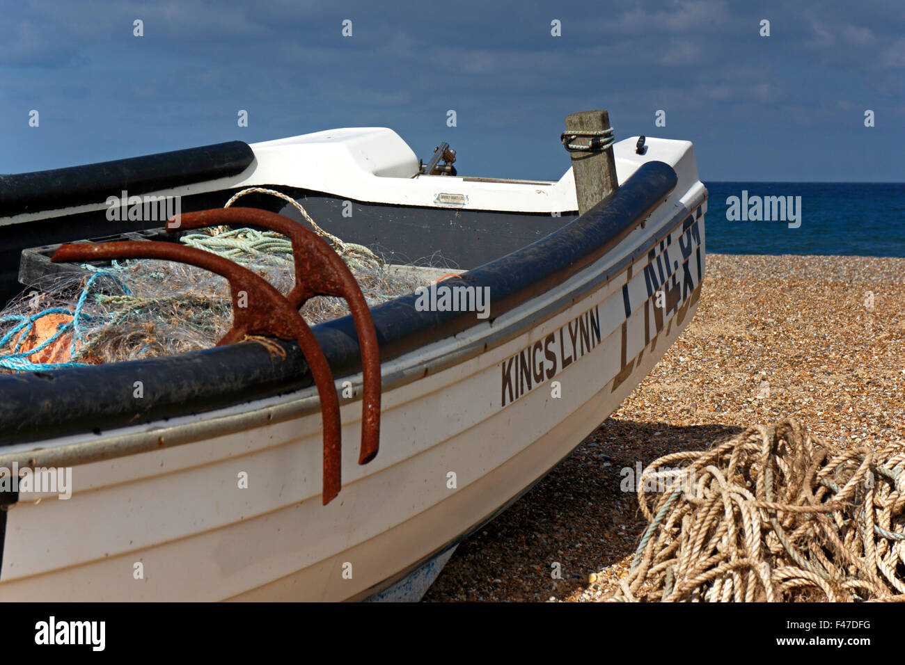 Small inshore fishing boat with equipment on the beach at Cley-next-the ...