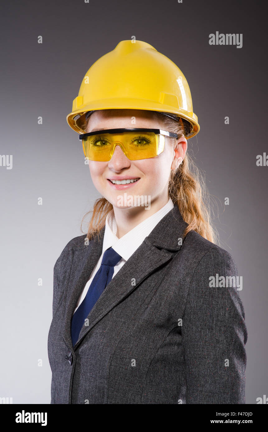 Female engineer with helmet isolated on gray Stock Photo - Alamy