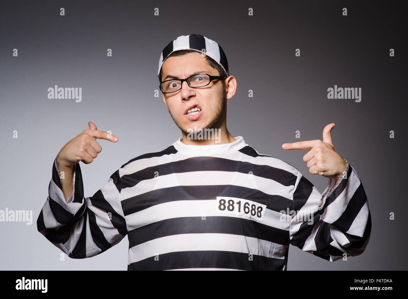 Funny prisoner isolated on gray Stock Photo - Alamy