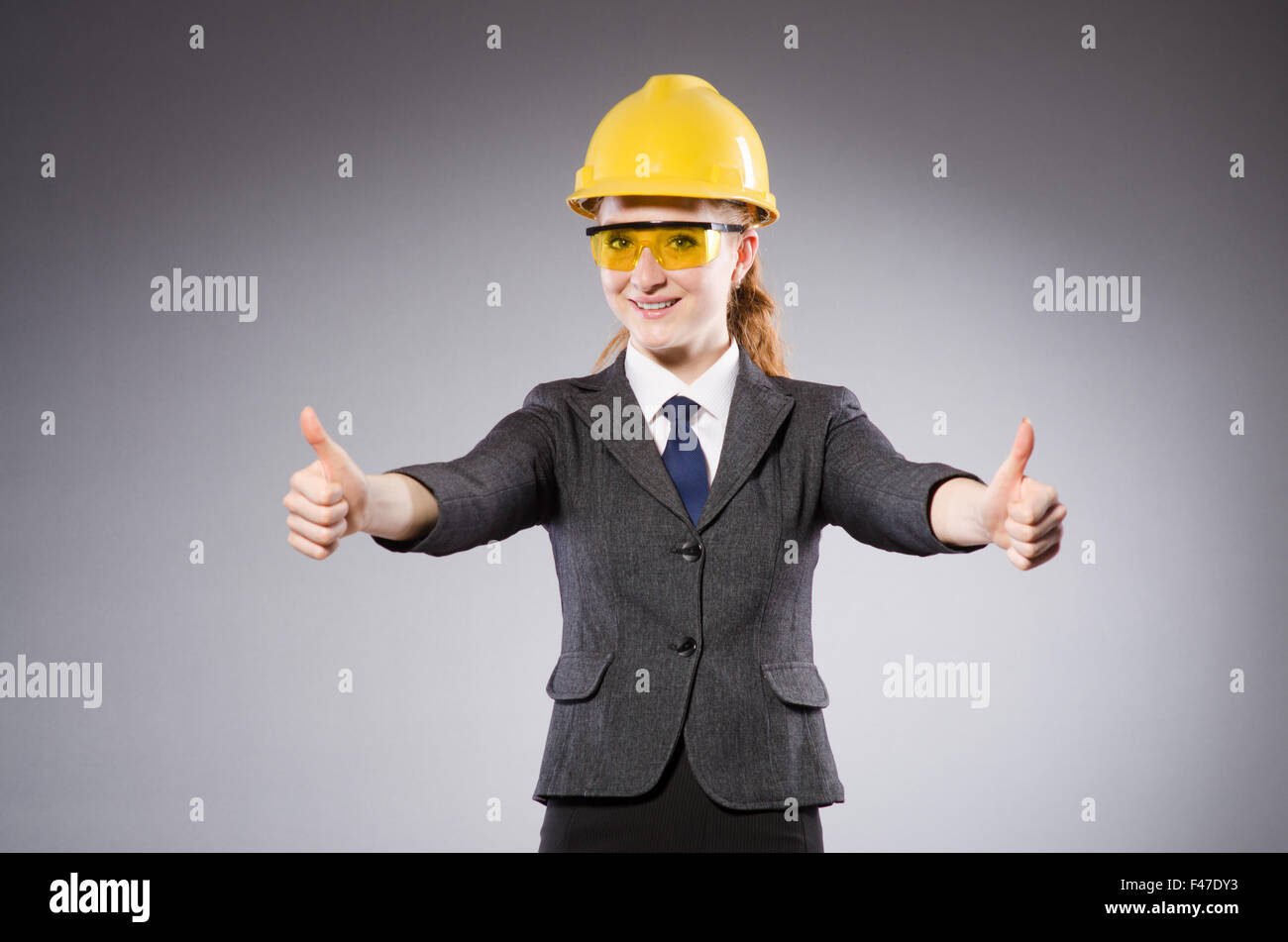 Female engineer with helmet isolated on gray Stock Photo - Alamy