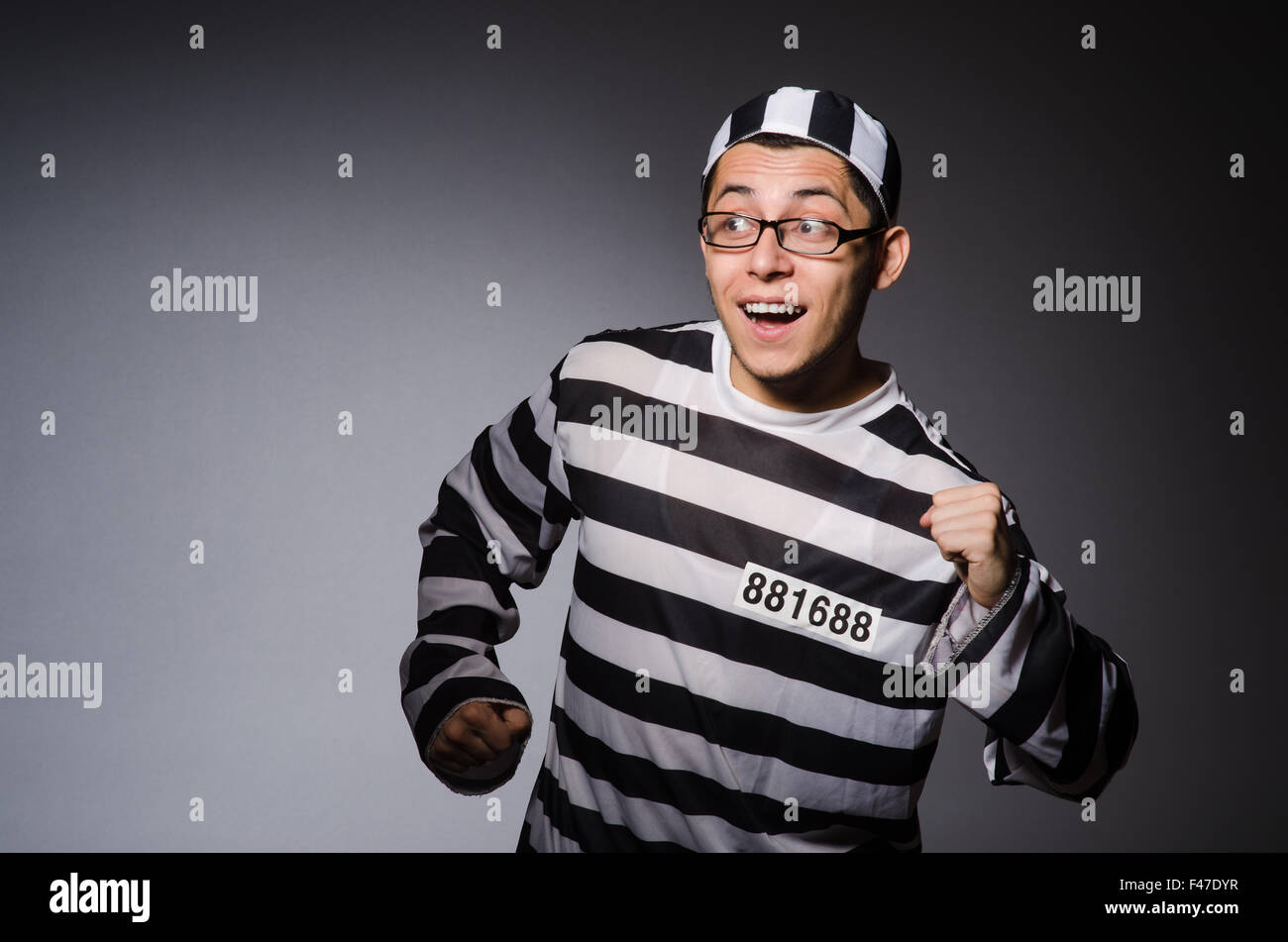 Funny prisoner isolated on gray Stock Photo - Alamy