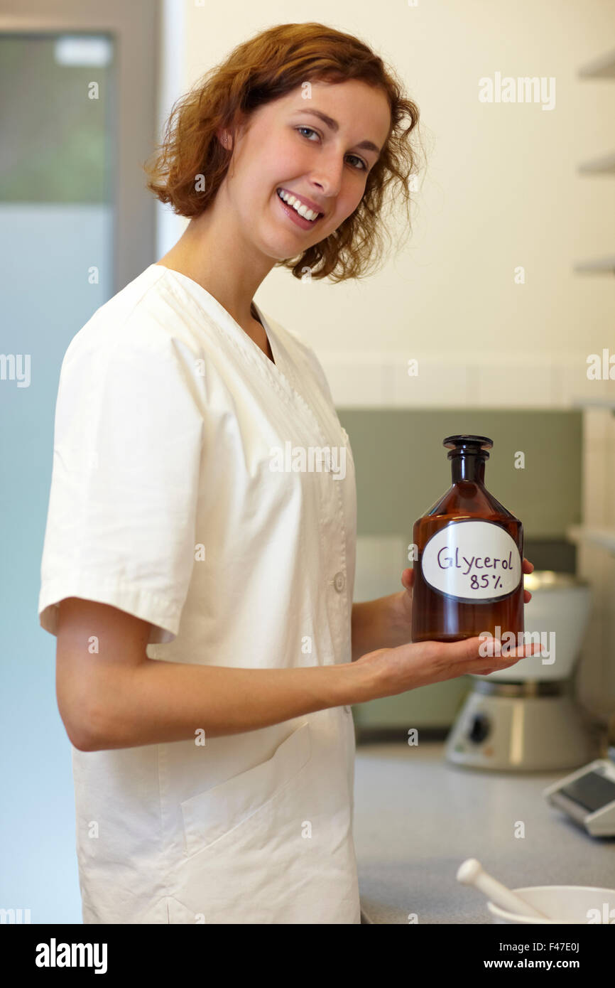 Pharmacist in lab holding bottle with glycerol Stock Photo - Alamy