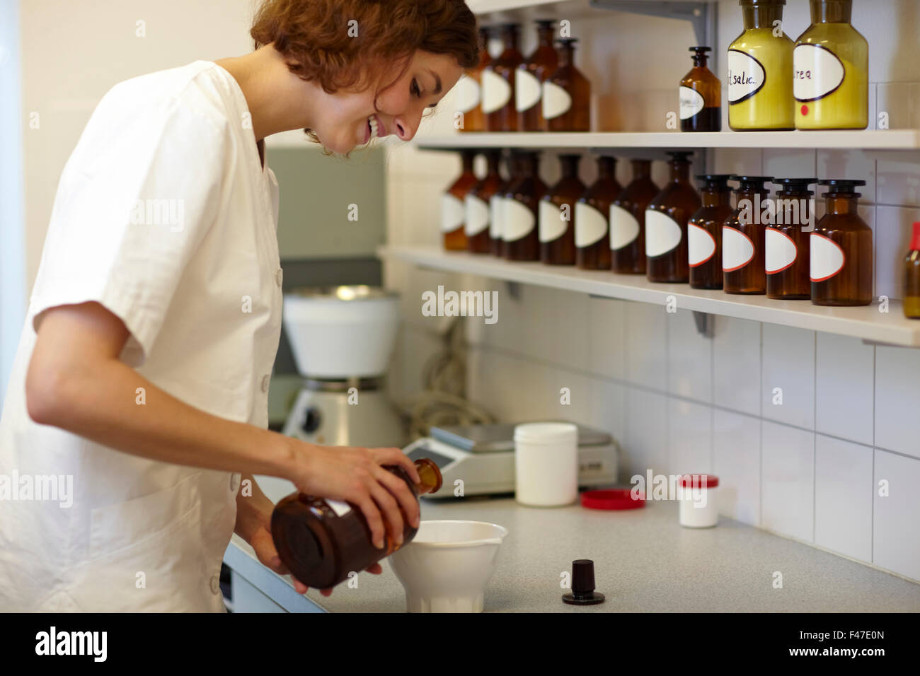 Female pharmacist mixing drug ingredients in lab Stock Photo - Alamy