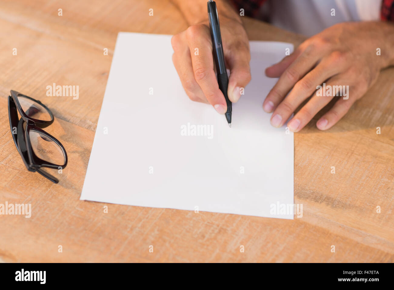 Hand writing on white page on working desk Stock Photo - Alamy