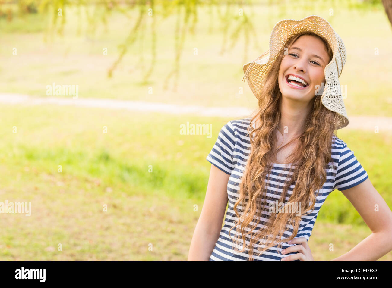 Pretty brunette wearing straw hat Stock Photo - Alamy