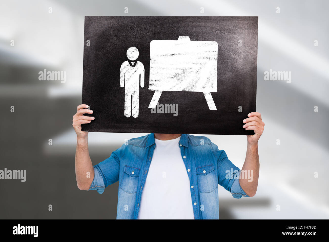 Composite image of casual man showing board Stock Photo - Alamy