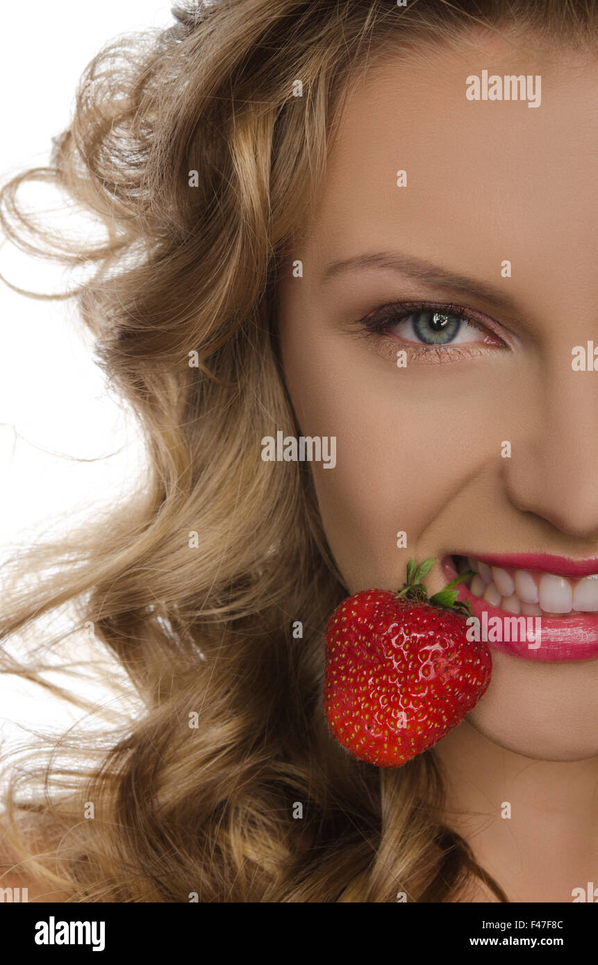 Young woman with strawberry teeth Stock Photo - Alamy