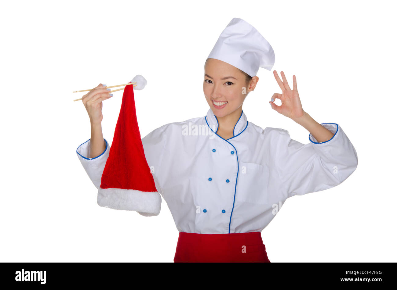 Chef holding chopsticks cap of Santa Claus Stock Photo - Alamy