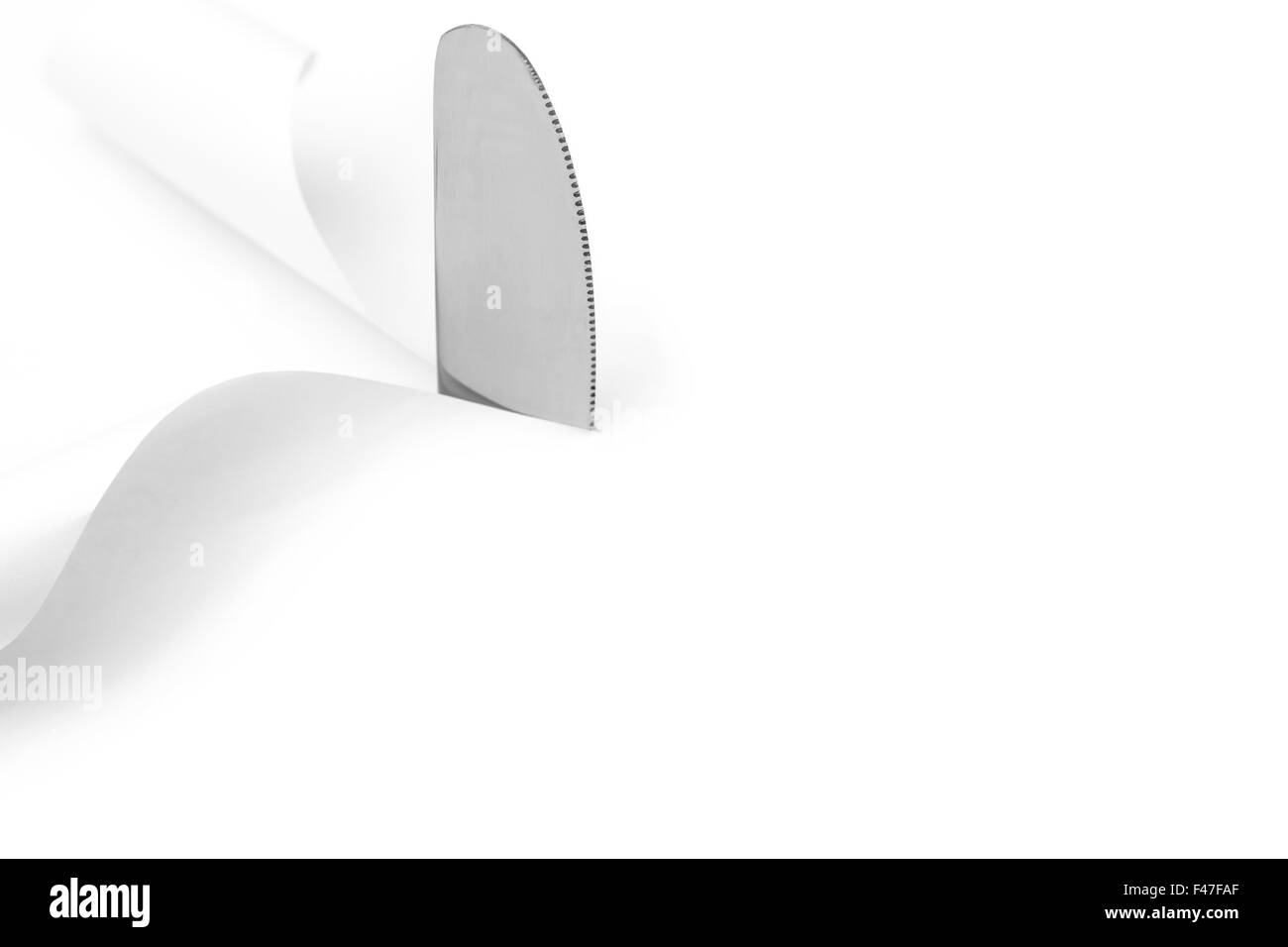 knife blade cuts white paper on a white background Stock Photo - Alamy