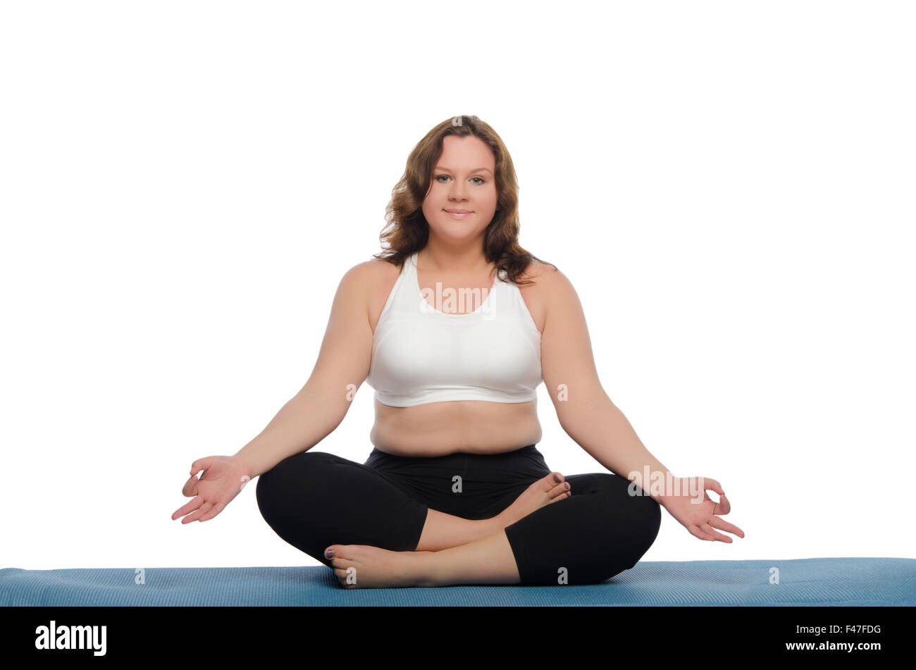 overweight woman practices yoga on mat Stock Photo - Alamy
