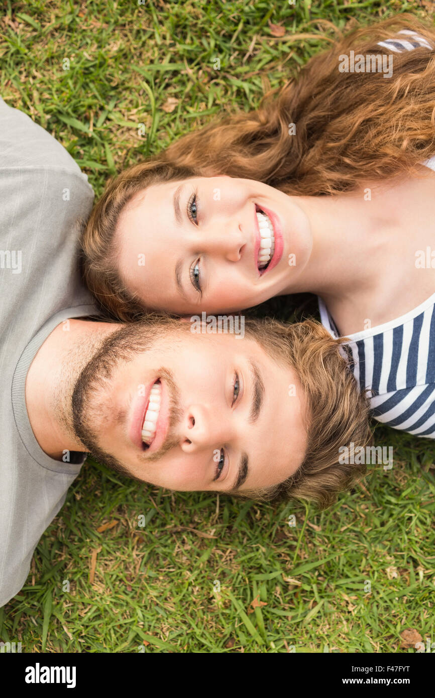 Cute couple relaxing in the grass in the park Stock Photo - Alamy