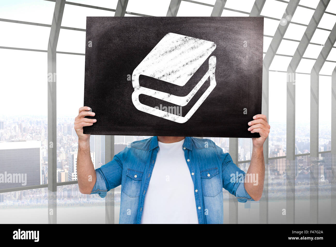 Composite image of casual man showing board Stock Photo - Alamy