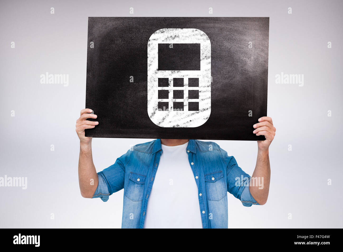 Composite image of casual man showing board Stock Photo - Alamy