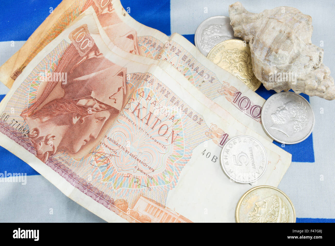 Greek old currency drachma banknotes piled on the Greek flag Stock ...