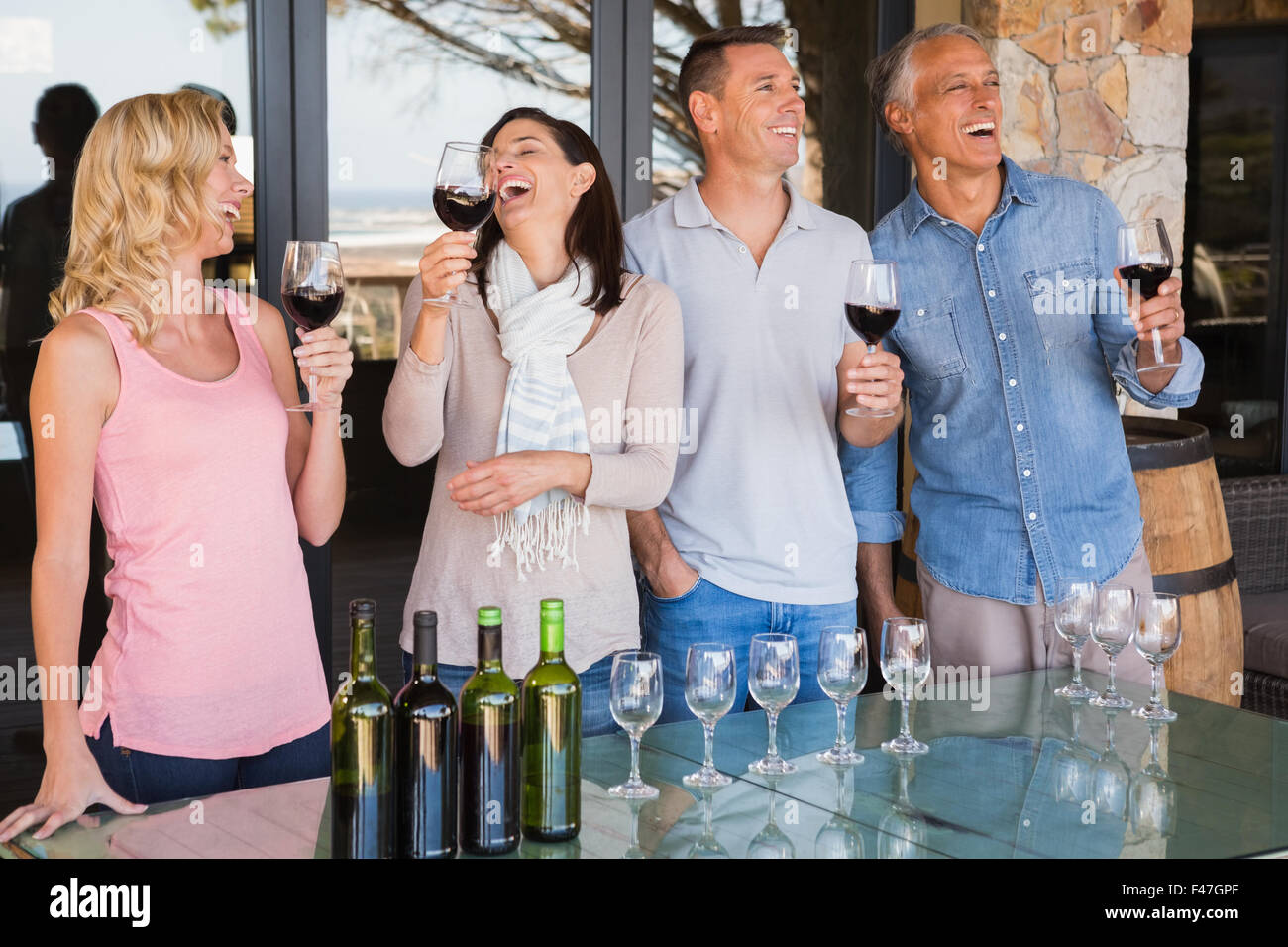 Happy friends in a wine tasting having wine Stock Photo - Alamy
