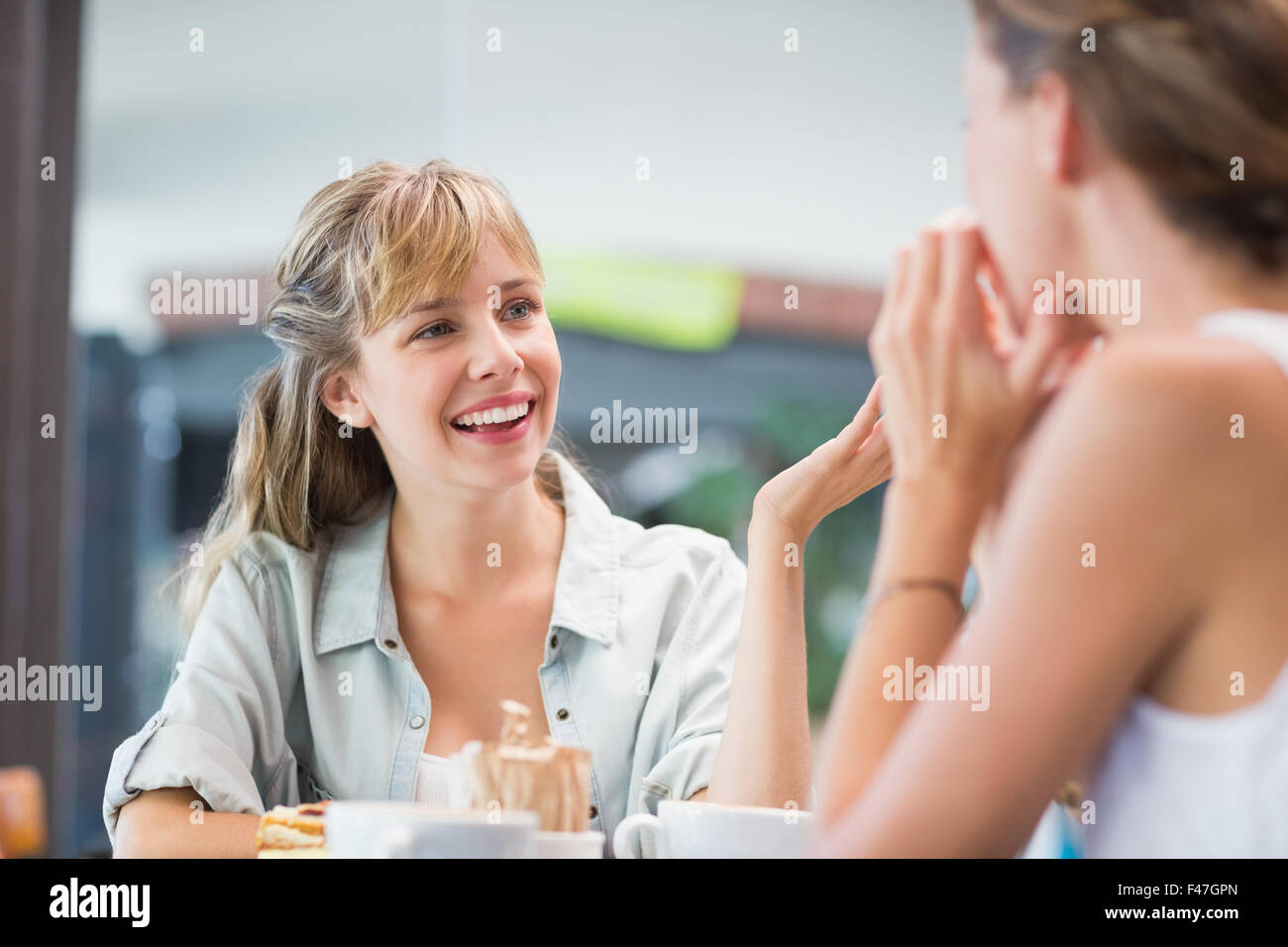 Beautiful women talking and looking at each other Stock Photo - Alamy
