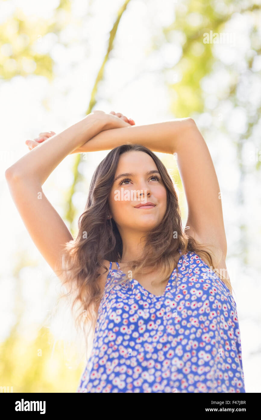 Pretty brunette standing arms raised Stock Photo - Alamy