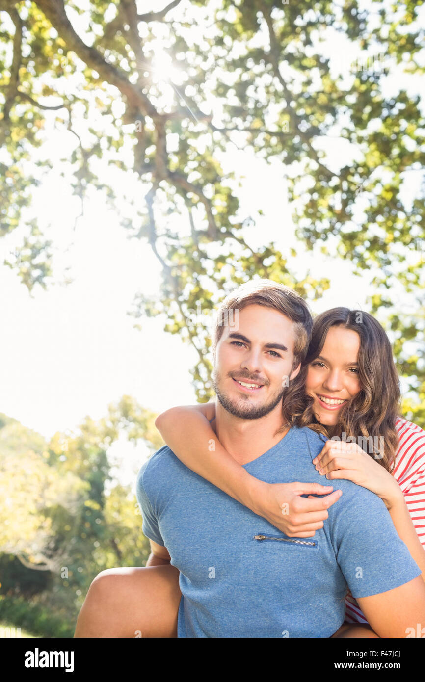 Cute couple having fun in park Stock Photo - Alamy