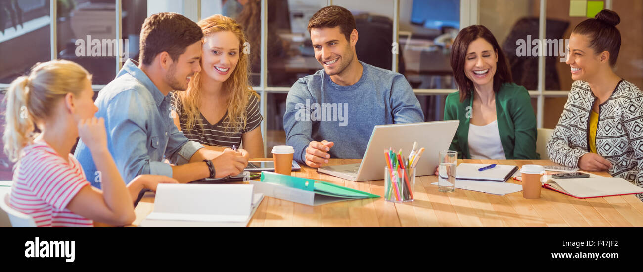 Group of young colleagues using laptop Stock Photo - Alamy
