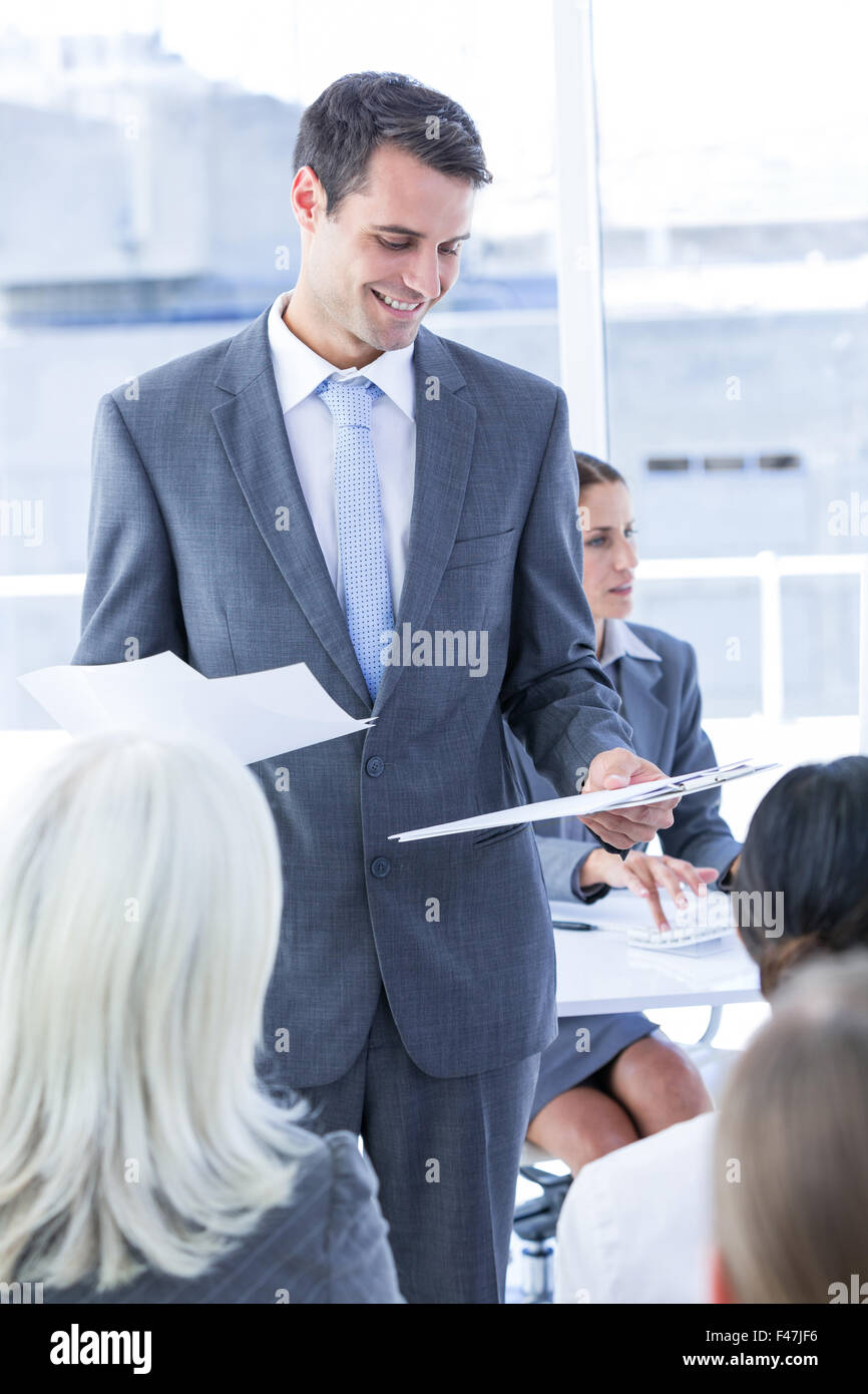 Businessman give a paper Stock Photo - Alamy